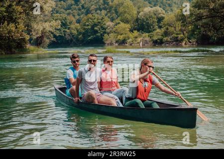 Group adventurous explorer friends are canoeing in a wild river ...