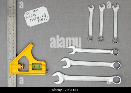Spanners laid out on textured board. Above image of tools layout with ...