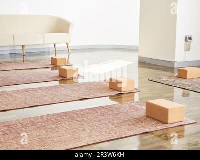 Room with multiple yoga mats Stock Photo - Alamy
