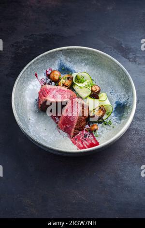 Fried Italian chianina beef fillet steak very rare with mushrooms Stock ...
