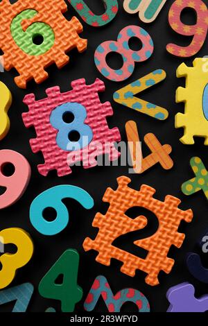 Many colorful numbers and mathematical symbols on black background ...