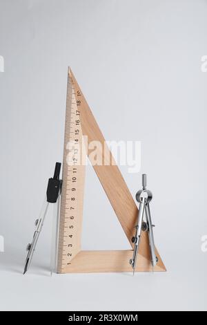 Ruler with measuring length markings, triangle and compass on white ...