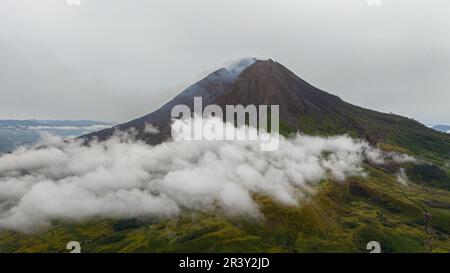Aerial view of active volcano Sinabung with clouds and smoke. Sumatra ...