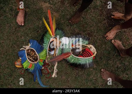 The head ornaments (cocar) and music instruments seen laying on the ...