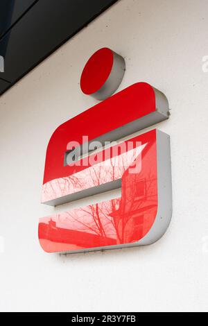 Illuminated sign with the symbol of the savings bank on a facade Stock ...