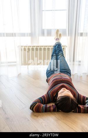 Woman Warming Up Her Feet On White Radiator At Home Stock Photo - Alamy