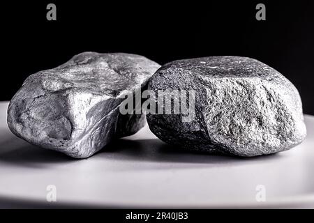 Manganese stones on electronic scale. Metal used in industry. Mineral ...