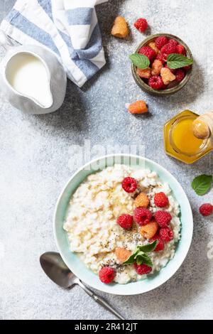 Breakfast - oat porridge with raspberry served mint Stock Photo - Alamy