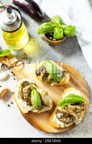 Open sandwiches set with grill aubergine and cream cheese on a stone ...