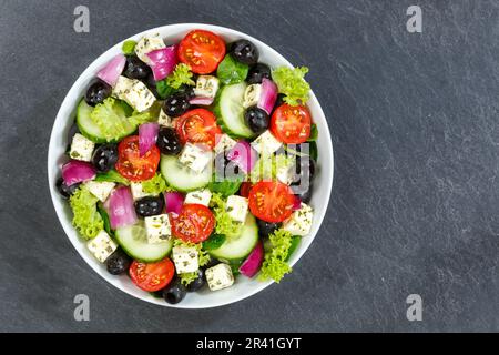 eating a Greek salad with feta cheese and pieces of dried rye bread ...