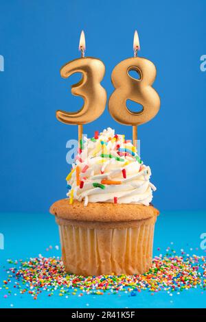 Number 38 blue celebration candle on white wooden background. Happy ...