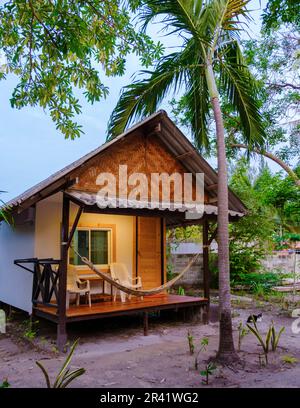 Bamboo hut bungalows on the beach in Thailand Stock Photo - Alamy