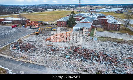 Drone aerial of deconstruction site of old abandoned hospital building ...