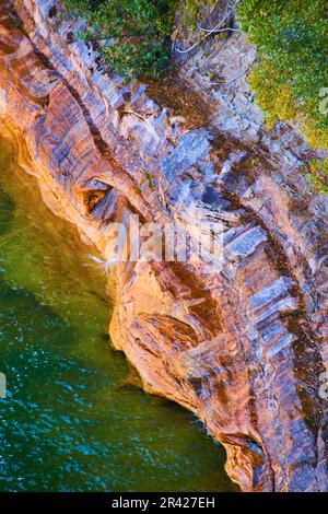 A drone shot of green coast on a sea under the cloudy sky, cool for ...