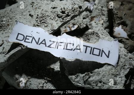 Paper with word Denazification on pieces of concrete, closeup Stock ...
