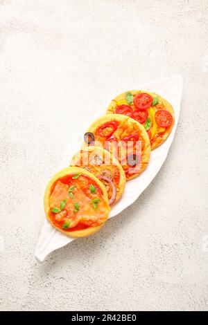 Plate with different tasty mini pizzas on white background Stock Photo ...