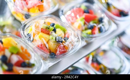 Plastic boxes with pre-packaged fruit and vegetable salads, put up for ...