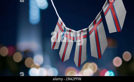 A garland of Faroe Islands national flags on an abstract blurred ...