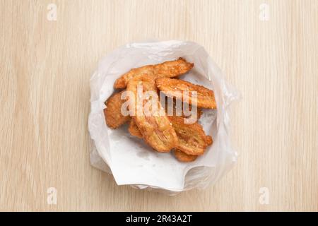 Kluay Khak or Kluay Tod ( Banana dipped ) in fried flour and packed in ...