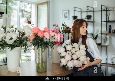 Florist workplace: Roses and florist accessories. Decor making Stock ...