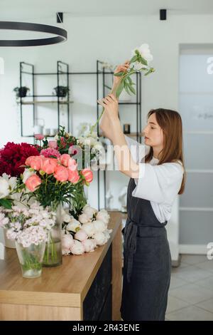Florist workplace: Roses and florist accessories. Decor making Stock ...