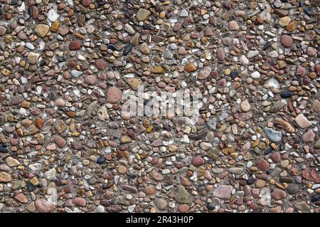 Full frame pebble dash background with multiple coloured embedded ...