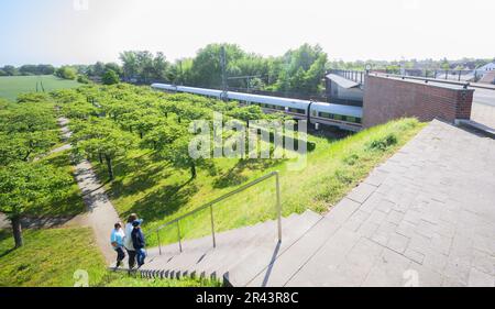 Eschede, Germany. 26th May, 2023. An ICE train passes the memorial for ...