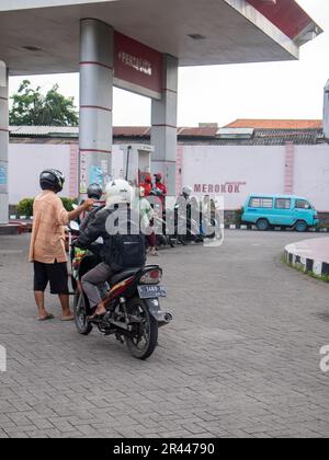 Queue of motorcycles are queuing to do refueling in Pertamina Gas ...