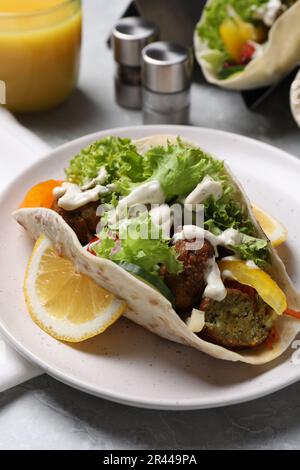 Delicious fresh vegan taco served on light grey marble table, space for ...