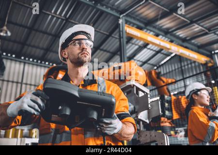 Industrial automation robotic teamwork working with circuit board on ...