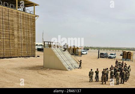Soldiers look on as the rappel master instructors prepare to ...