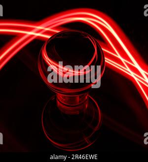 An intriguing red light emanating from a light bulb in a dimly lit ...