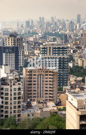 An aerial cityscape view of Tehran with multiple power lines ...