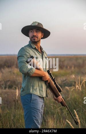 Hunter or ranger with gun or rifle in the forest hunting of some ...