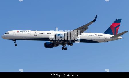 A Delta Airlines aircraft soaring against a blue sky backdrop Stock ...