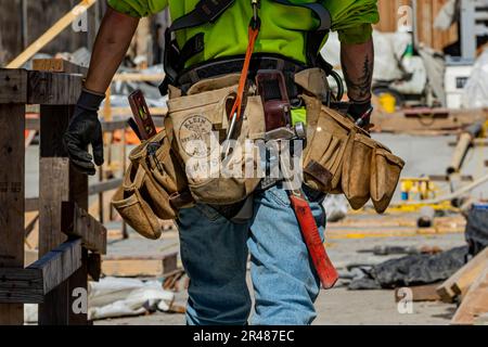 Construction laborers perform work on the chamber floor concrete infill ...