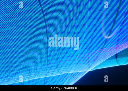 A large display featuring a pattern of blue lights radiating outward ...