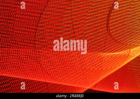 A large display featuring a pattern of red lights radiating outward ...