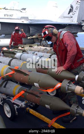 US Navy Loading bombs on aircraft at sea Stock Photo - Alamy