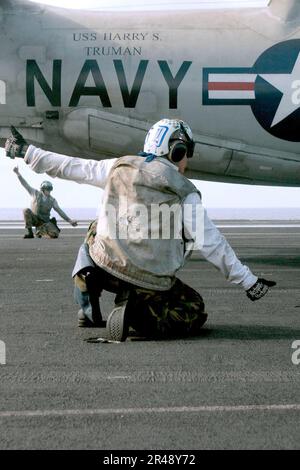 US Navy Aircraft handlers signal to the aircrew of an EA-6B Prowler ...