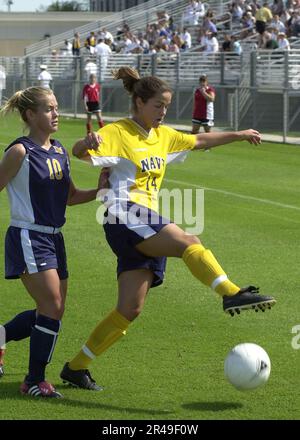 US Navy Navy forward Stacy Finley heads the ball away from Drexler ...
