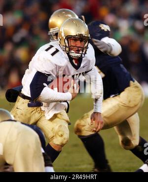 US Navy Navy quarterback Craig Candeto tries to out manuever Air Force ...