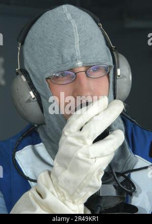 US Navy A Sailor uses a sound-powered telephone during a fueling at sea ...