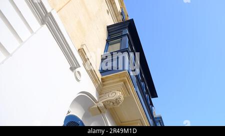 Bottom up view of typical maltese houses with blue wooden balcony with ...