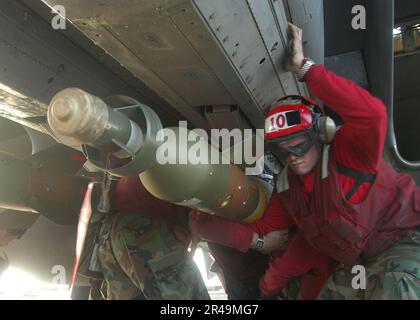 US Navy Aviation Ordnanceman load an AIM-54C Phoenix long-range air-to ...