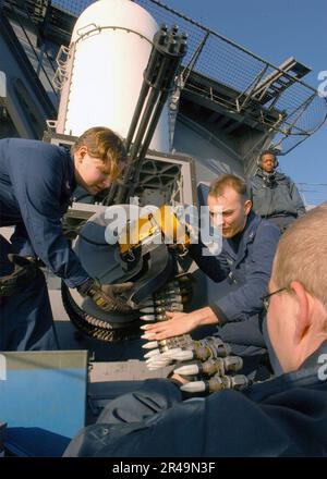 US Navy Fire Controlmen load a RIM-7 NATO Sea Sparrow missile during a ...