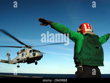 US Navy A Landing Signals Enlisted directs an SH-60F Seahawk to a safe ...