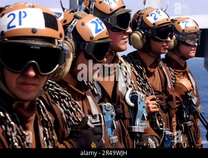 US Navy Squadron plane captains hold tie down chains used to tie down ...