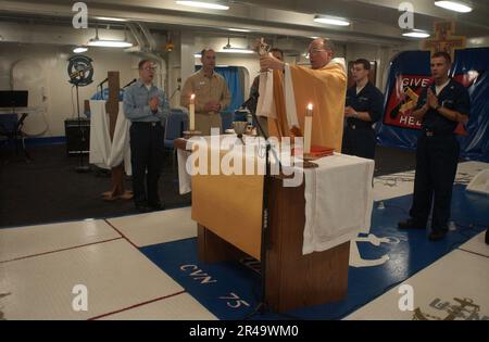US Navy Chaplain, prepares communion for Easter Mass in the forecastle ...