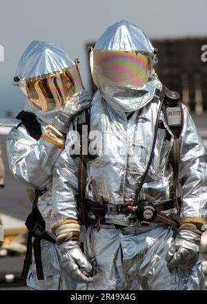 US Navy Members of the Crash and Salvage Crew aboard USS Bonhomme ...